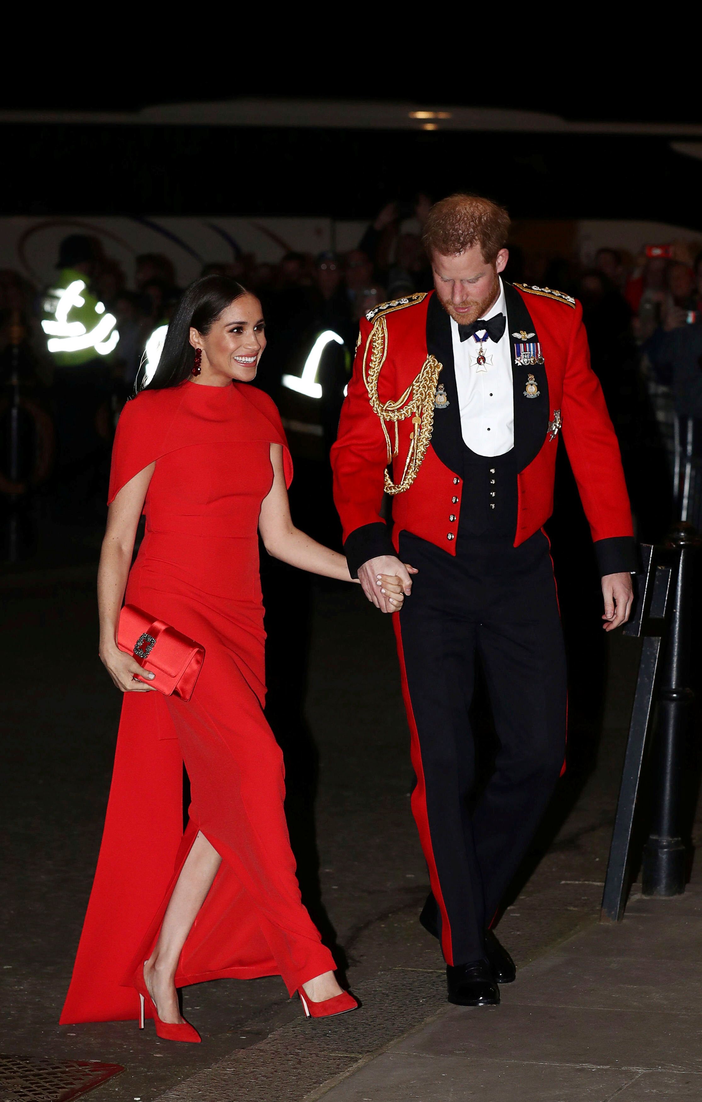 Meghan Markle Stuns In Red Cape Dress At Mountbatten Music Festival - Fame10